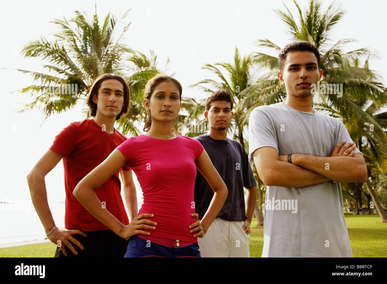 Young adults standing, looking at camera Stock Photo - Alamy