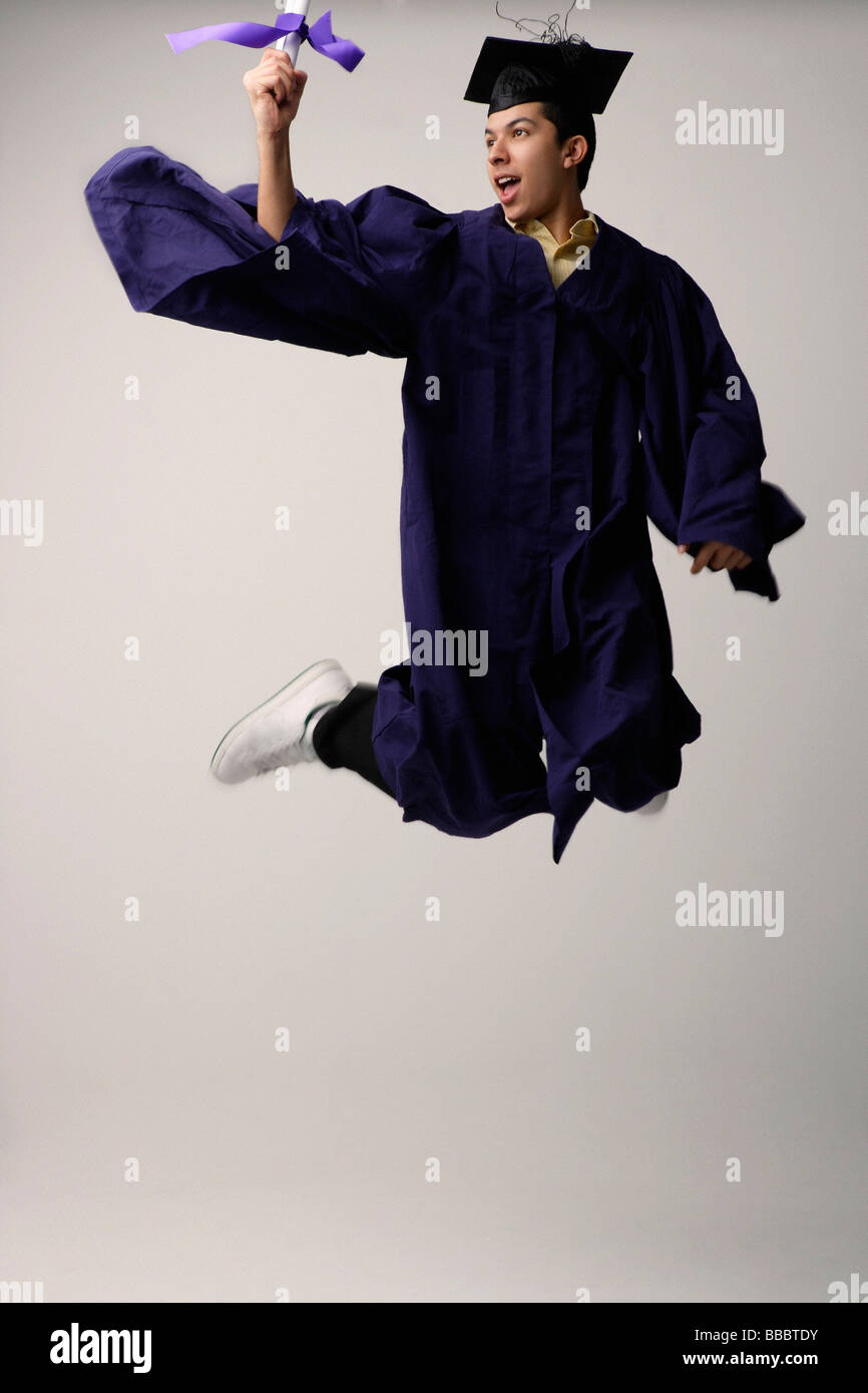 Graduate jumping for joy Stock Photo - Alamy