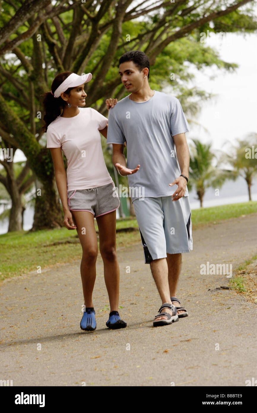 Couple walking side by side, talking Stock Photo - Alamy