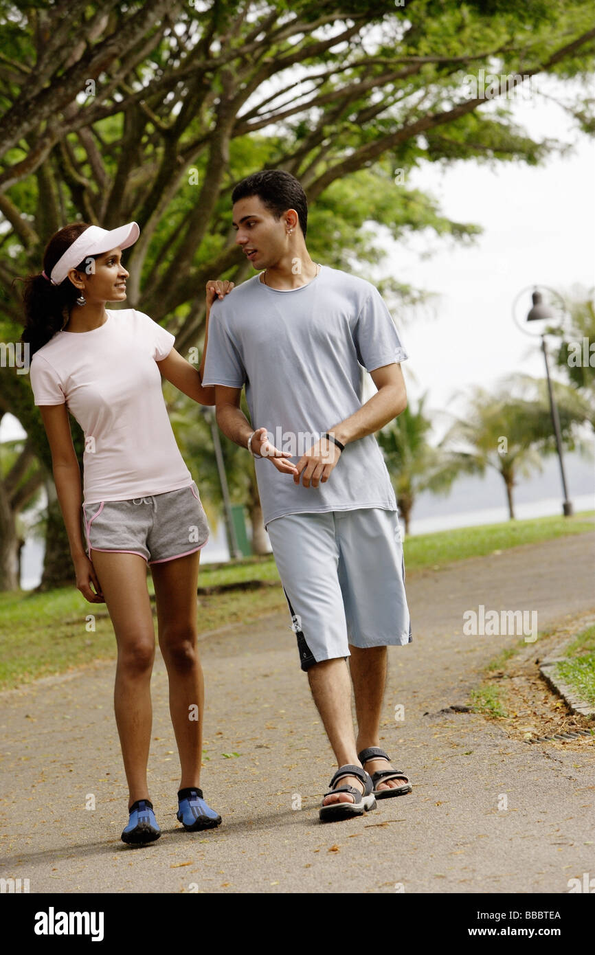 Couple walking side by side, talking Stock Photo - Alamy