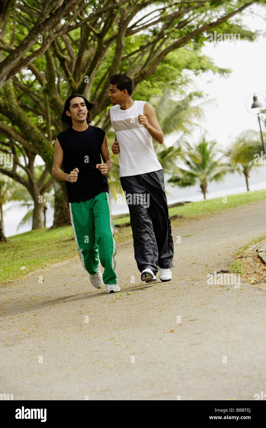 Young men jogging in park Stock Photo - Alamy
