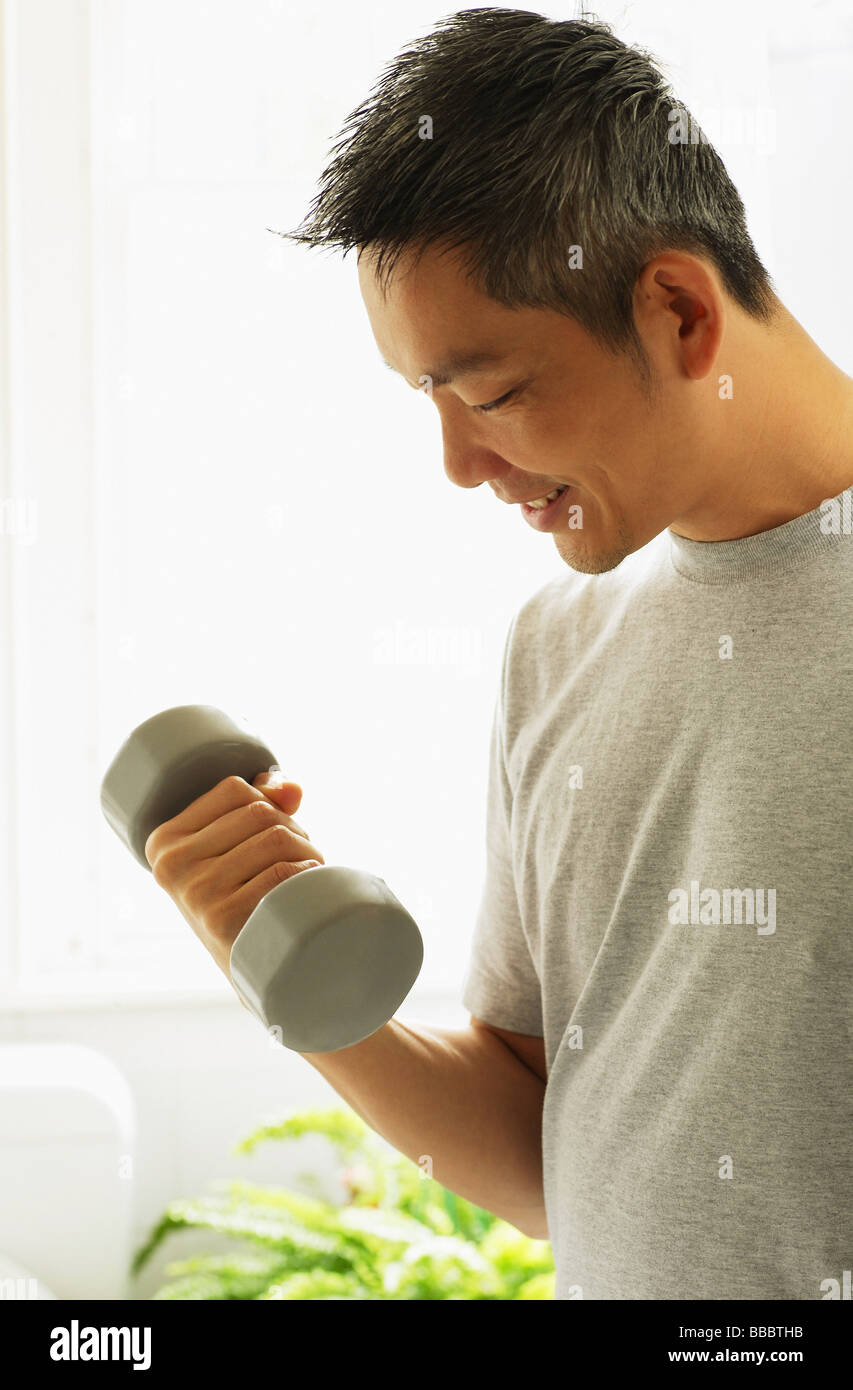 Smiling chinese man lifting hi-res stock photography and images - Alamy