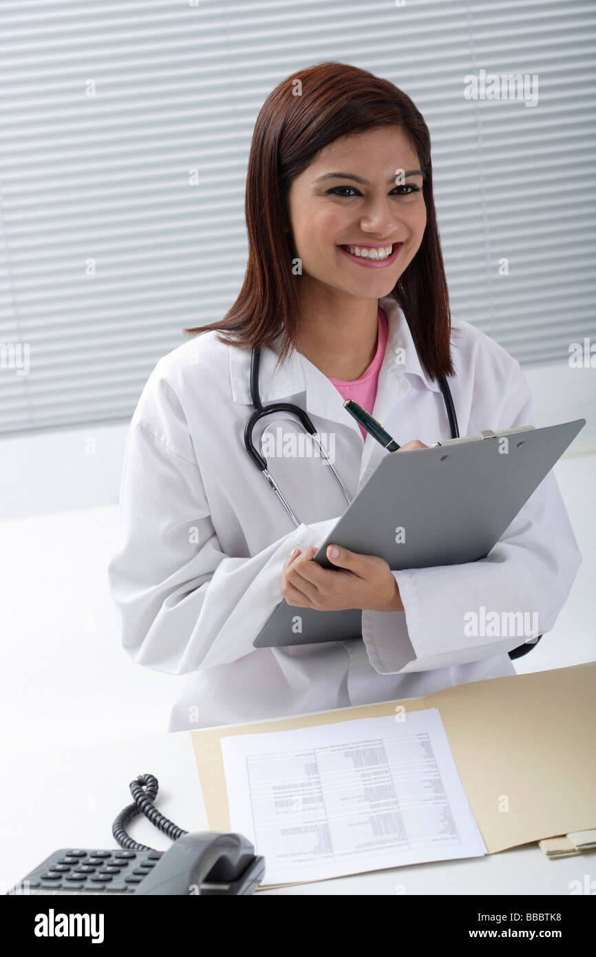 Doctor smiling with report in hand Stock Photo - Alamy
