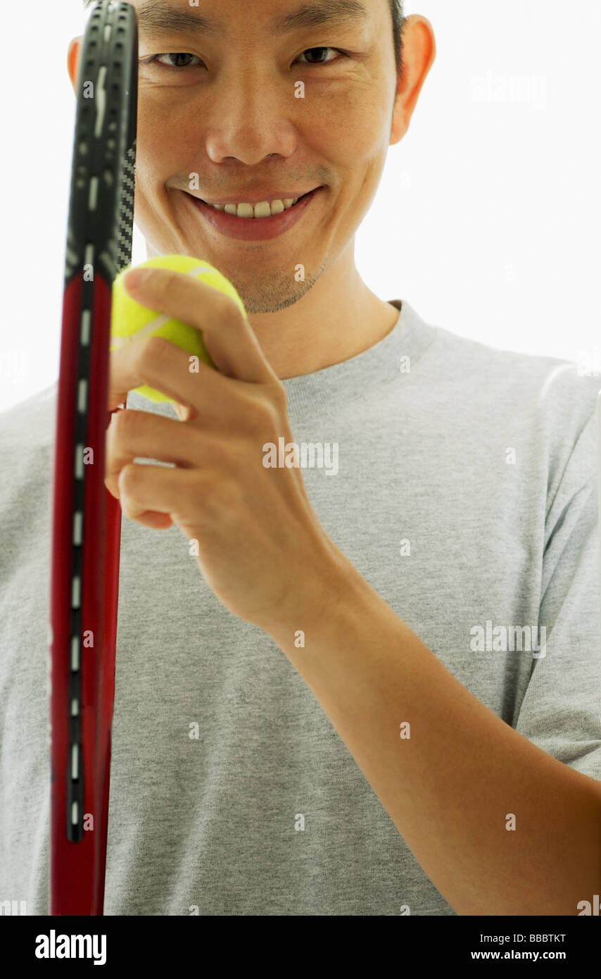 Man holding tennis racket and tennis ball Stock Photo - Alamy