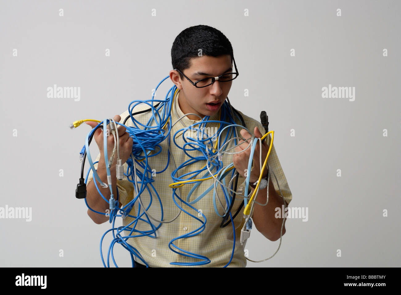 Man with cords and wires around his neck Stock Photo - Alamy