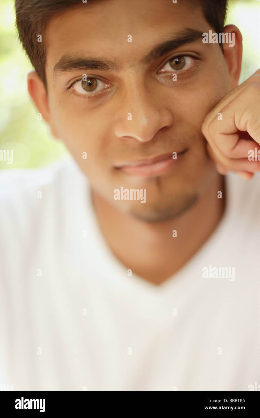 Man looking at camera, hand on face Stock Photo - Alamy