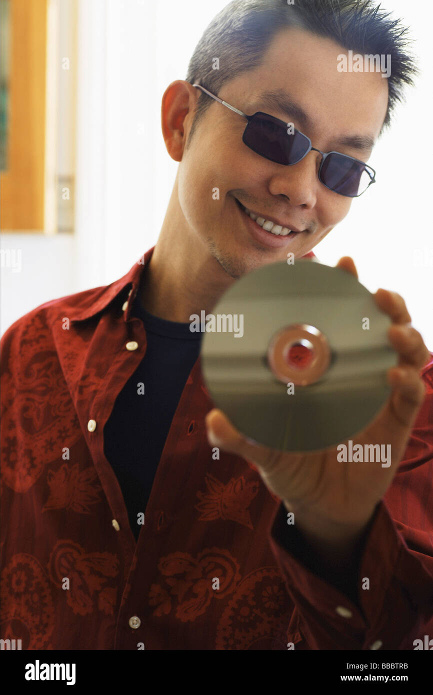 Man looking at camera, holding CD Stock Photo - Alamy