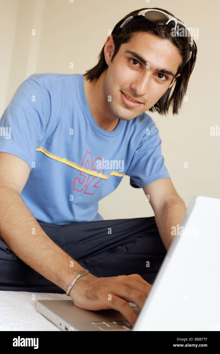 Man in front of laptop, looking at camera Stock Photo - Alamy