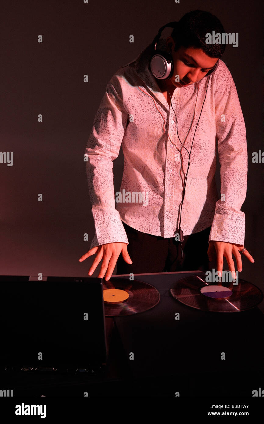 Young man working as DJ Stock Photo - Alamy