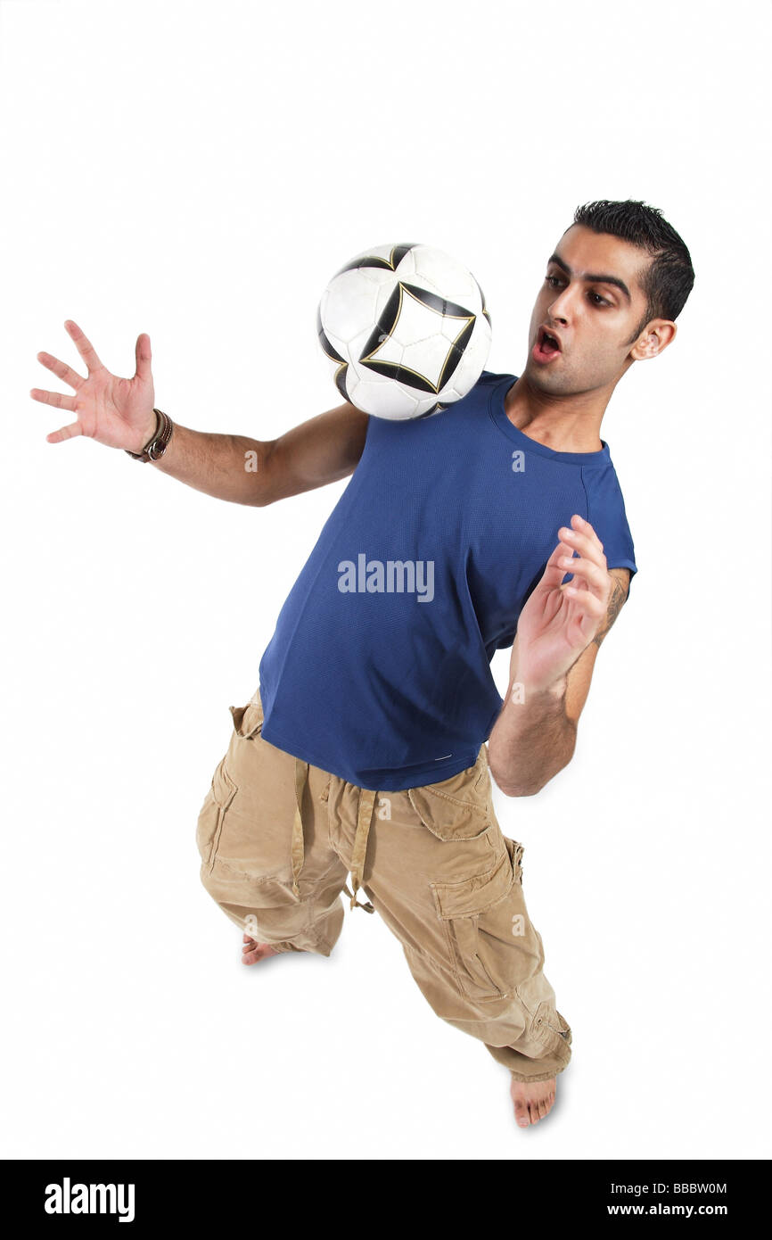 Young man bouncing soccer ball on his chest Stock Photo - Alamy