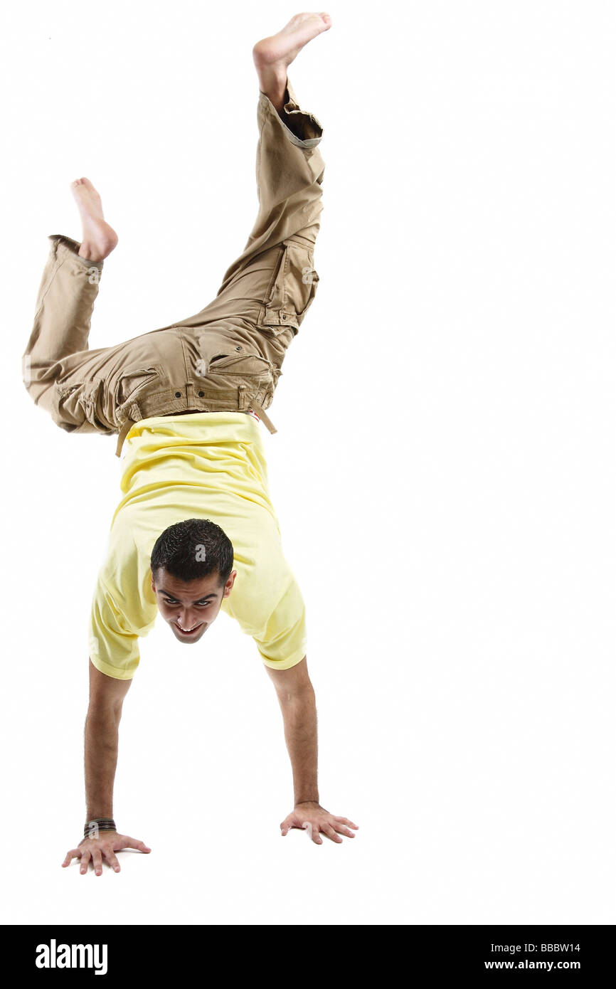 Young man balancing on his hands, legs up Stock Photo - Alamy
