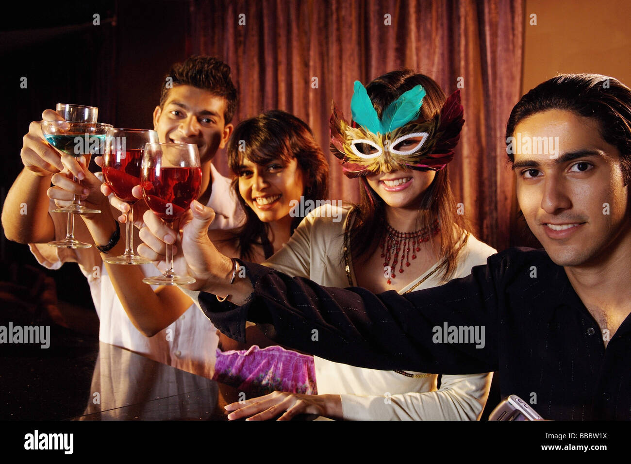 Couples at bar, toasting, looking at camera Stock Photo - Alamy