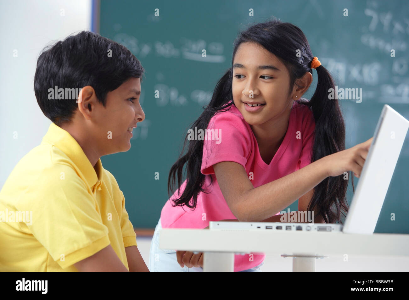 two students at laptop, girl pointing to screen Stock Photo - Alamy