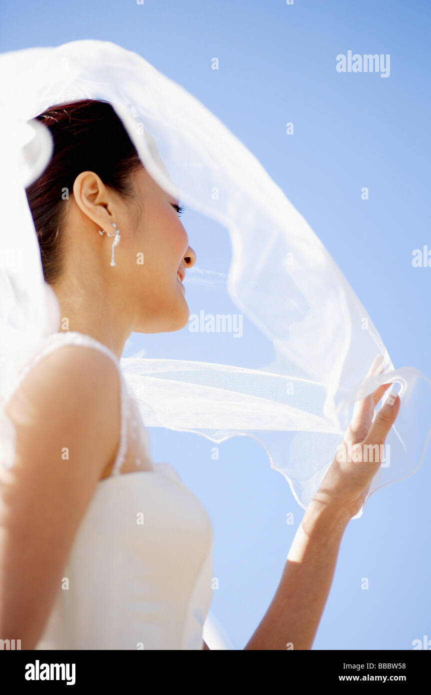Bride touching veil Stock Photo - Alamy