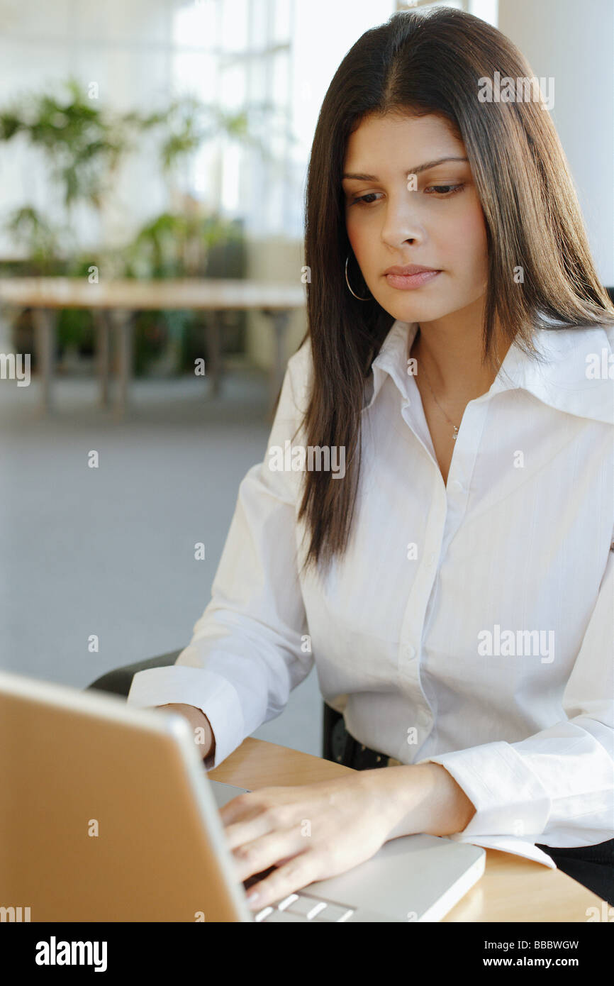 Female executive using laptop, portrait Stock Photo - Alamy