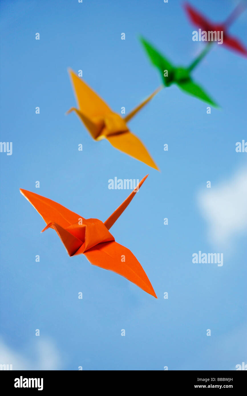 multiple paper cranes against sky backdrop Stock Photo - Alamy