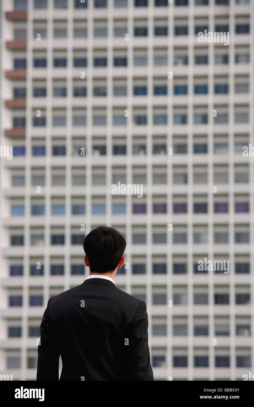 Businessman looking at building, rear view Stock Photo - Alamy