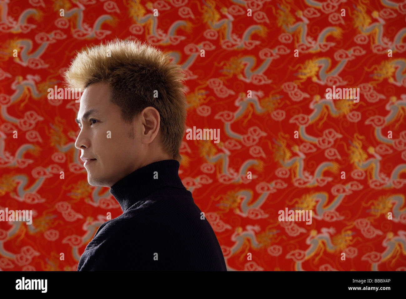Profile of smiling man, Chinese silk backdrop Stock Photo - Alamy