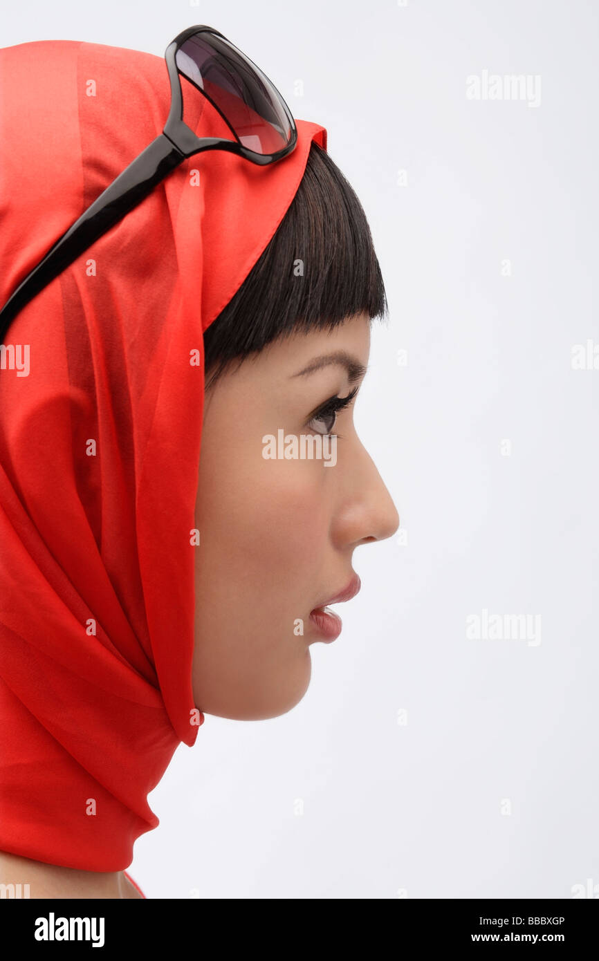 Profile of woman wearing red scarf and sunglasses Stock Photo - Alamy