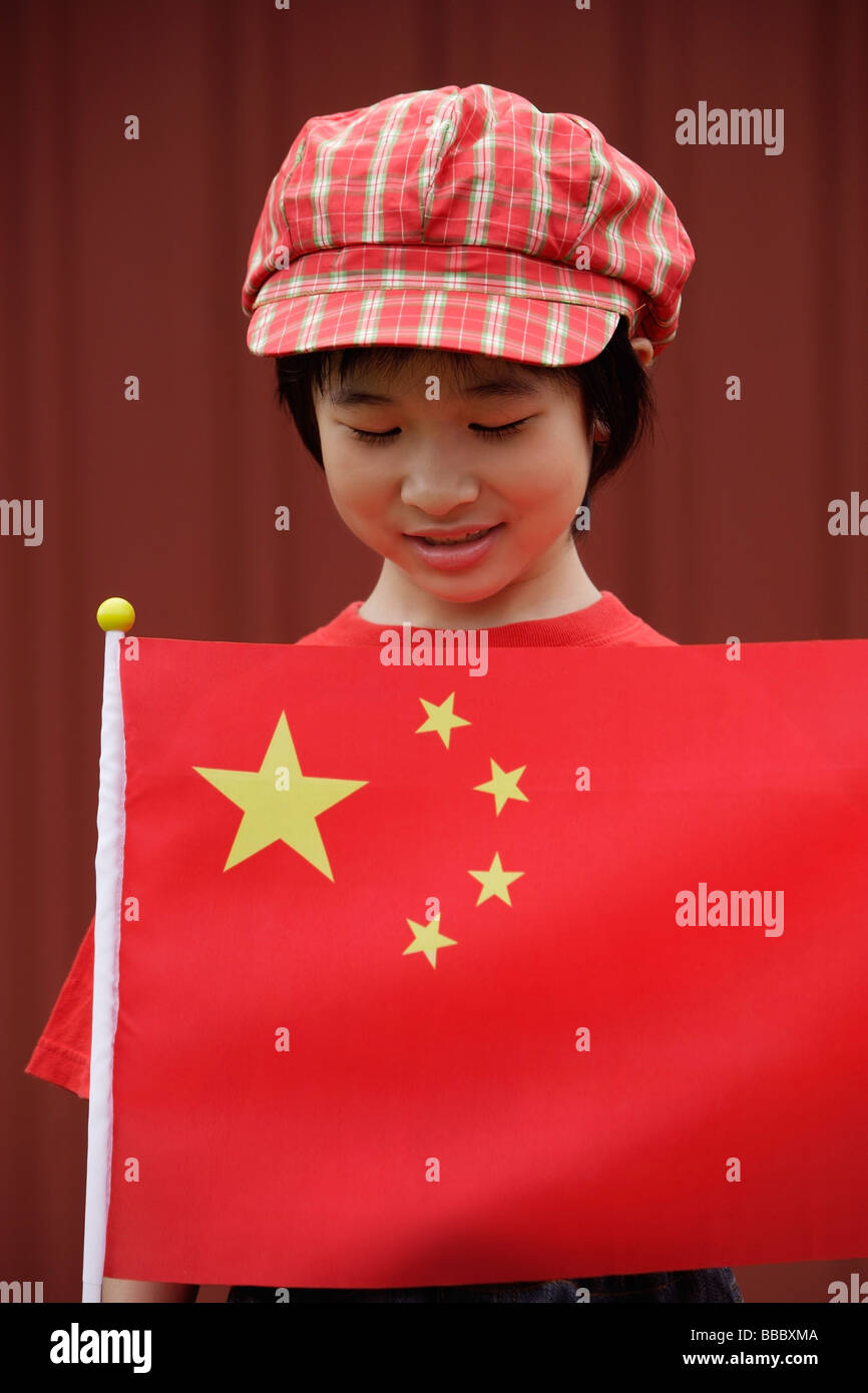 Portrait of little girl standing behind Chinese flag Stock Photo - Alamy
