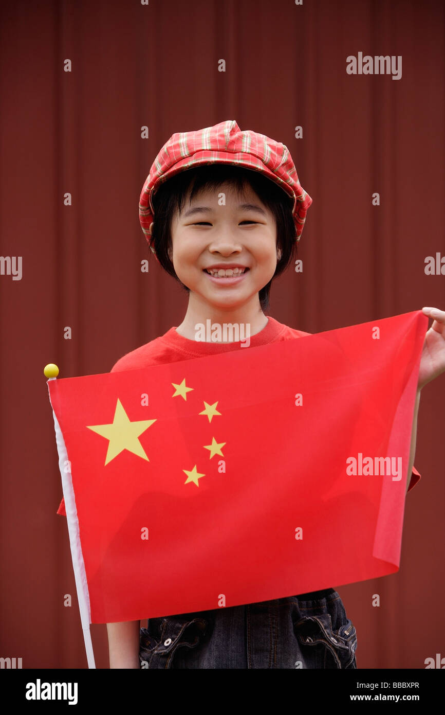 Portrait of little girl standing behind Chinese flag Stock Photo - Alamy