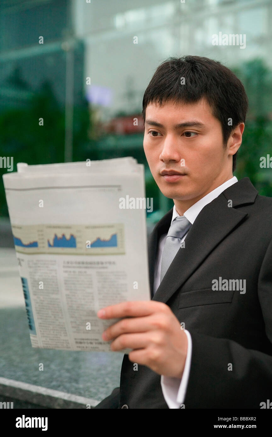 Businessman using reading newspaper Stock Photo - Alamy