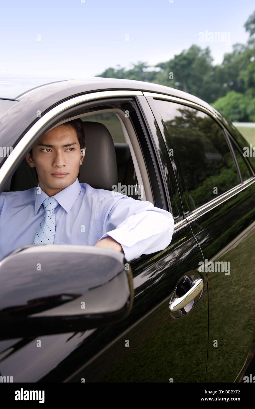 Man looking out car window Stock Photo - Alamy