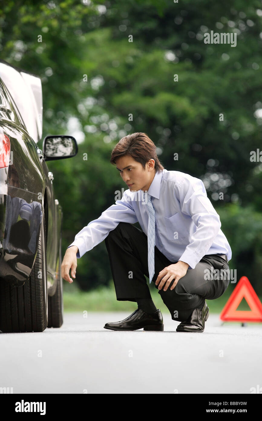 Man inspecting car Stock Photo - Alamy