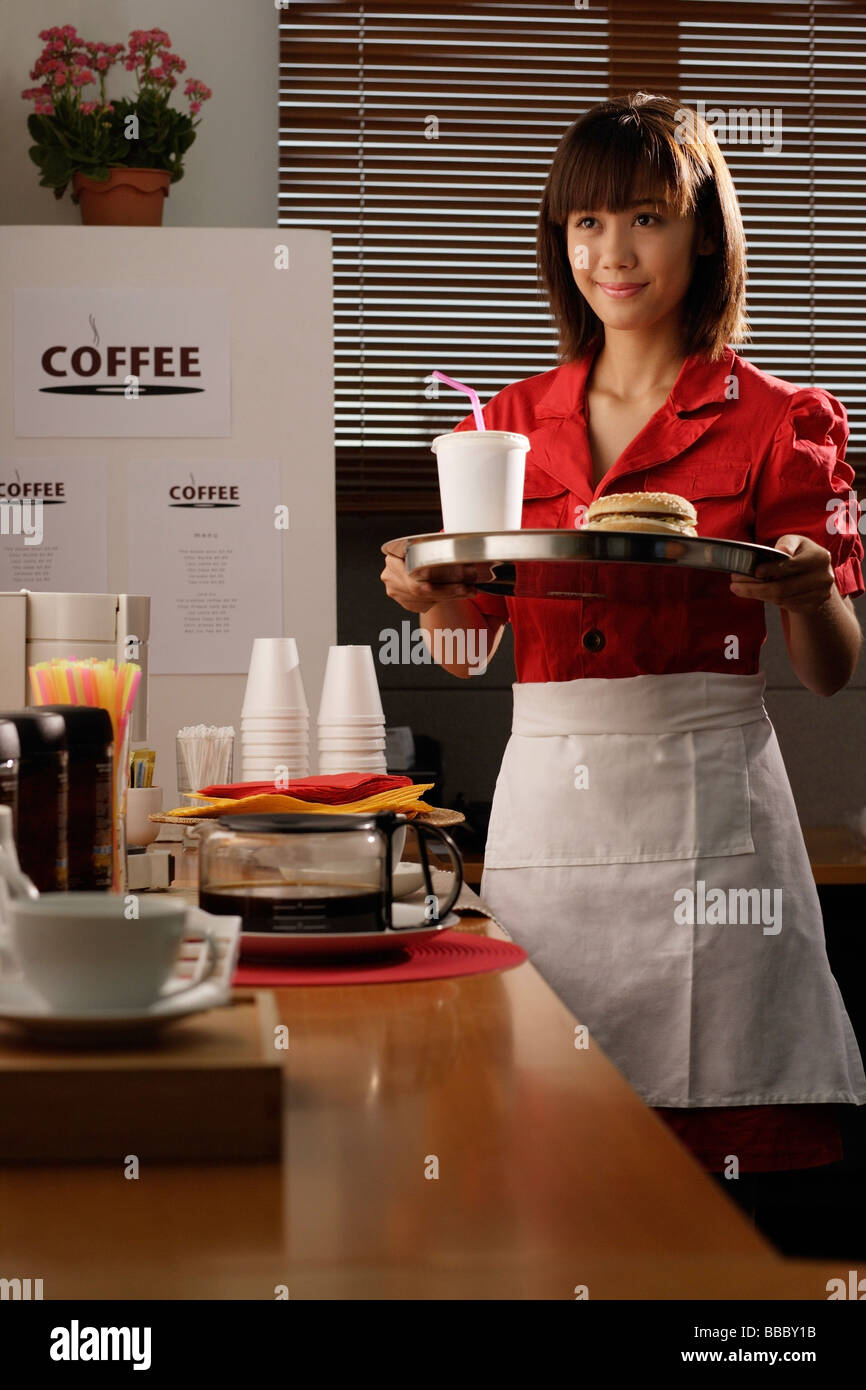 Waitress in diner serving burger and drink Stock Photo - Alamy