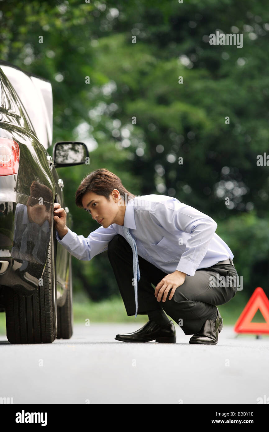 Man inspecting car Stock Photo - Alamy