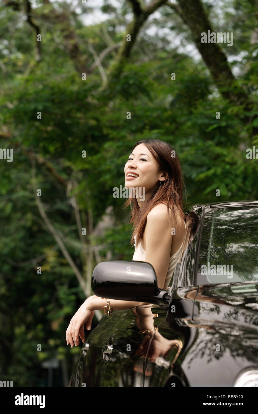 Woman hanging out car window Stock Photo - Alamy