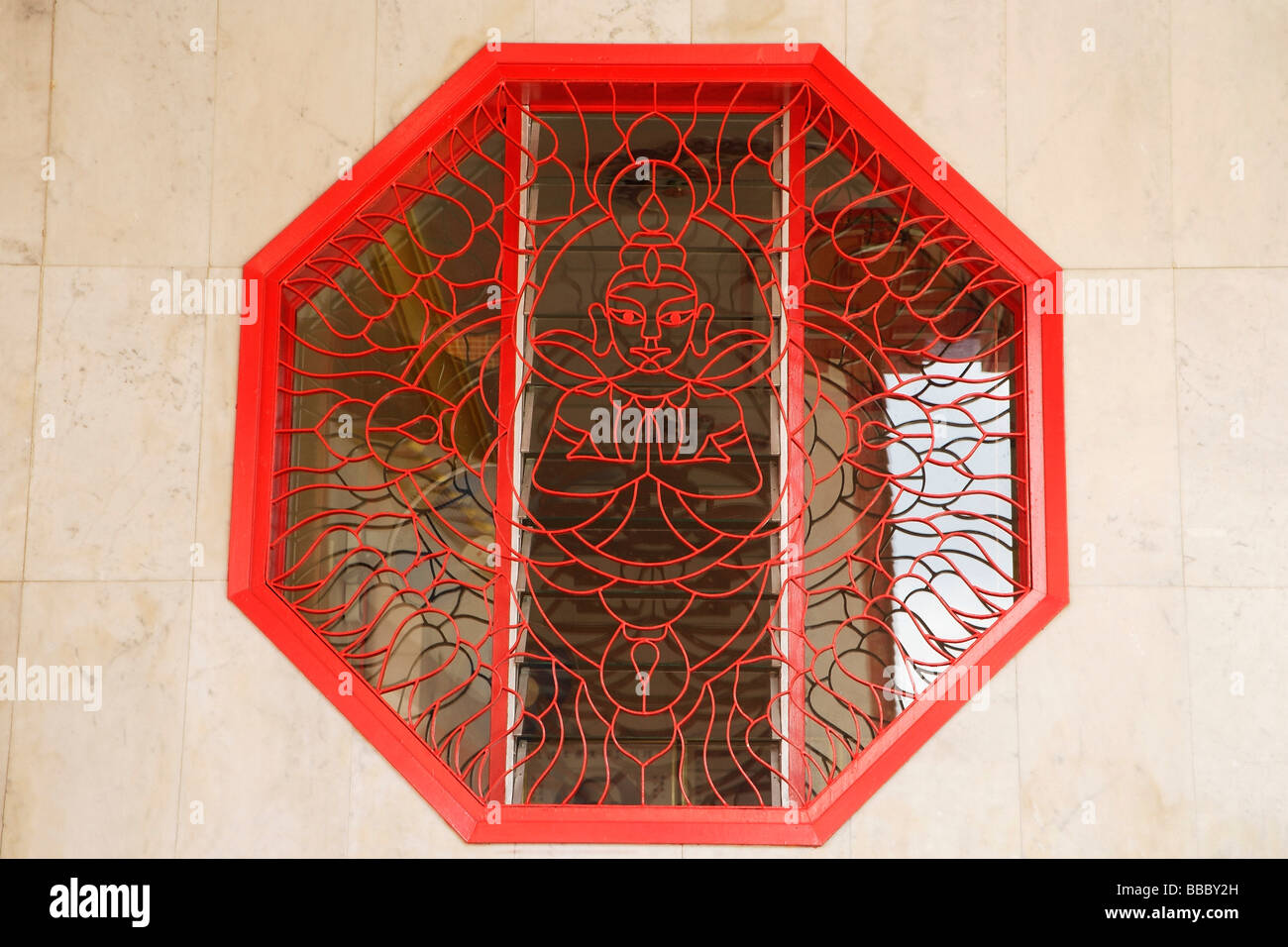 Octagonal window with lattice work showing Buddha Stock Photo - Alamy
