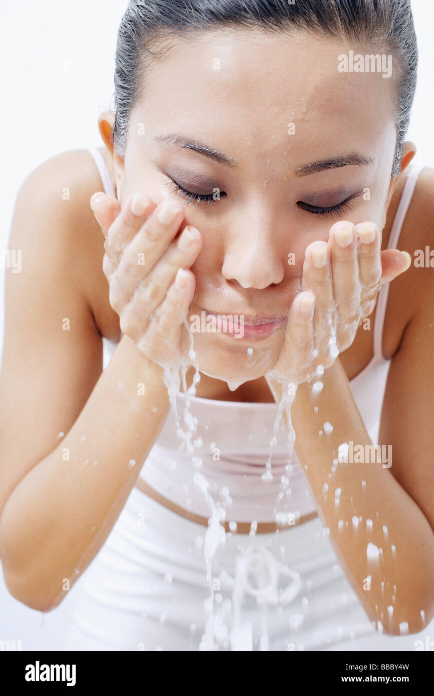 Woman splashing face with water Stock Photo - Alamy