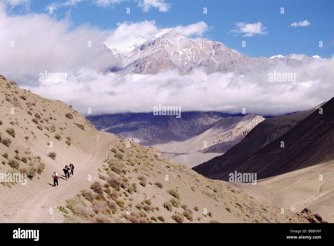 Nepal, Mustang, Tourists walking along high path, surrounded by ...