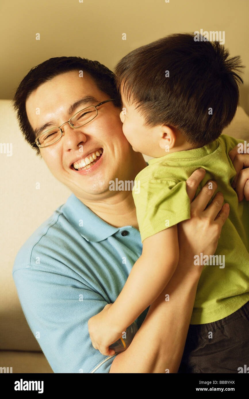 Son kissing father Stock Photo - Alamy