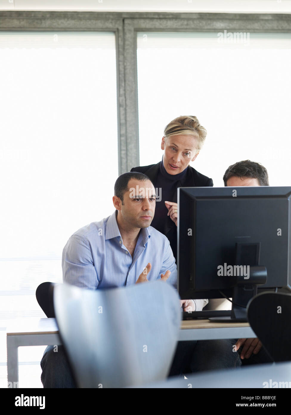 Group of business people at office desk Stock Photo - Alamy