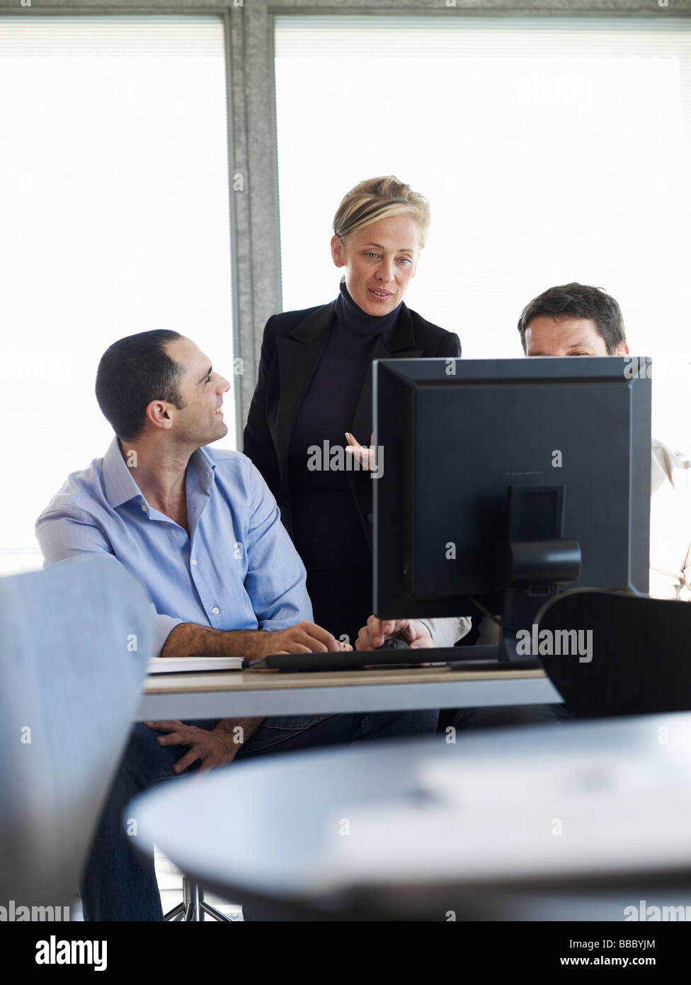 Group of business people at office desk Stock Photo - Alamy