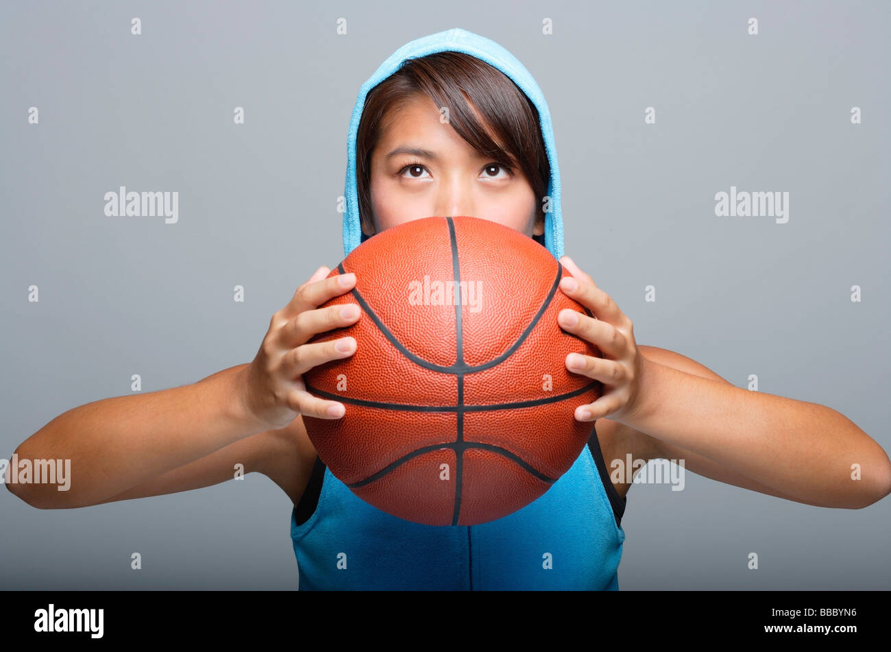Young woman with basketball looking up Stock Photo - Alamy