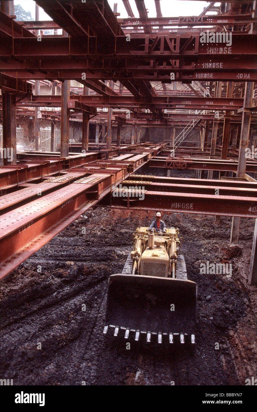 Construction site, man operating bulldozer Stock Photo - Alamy