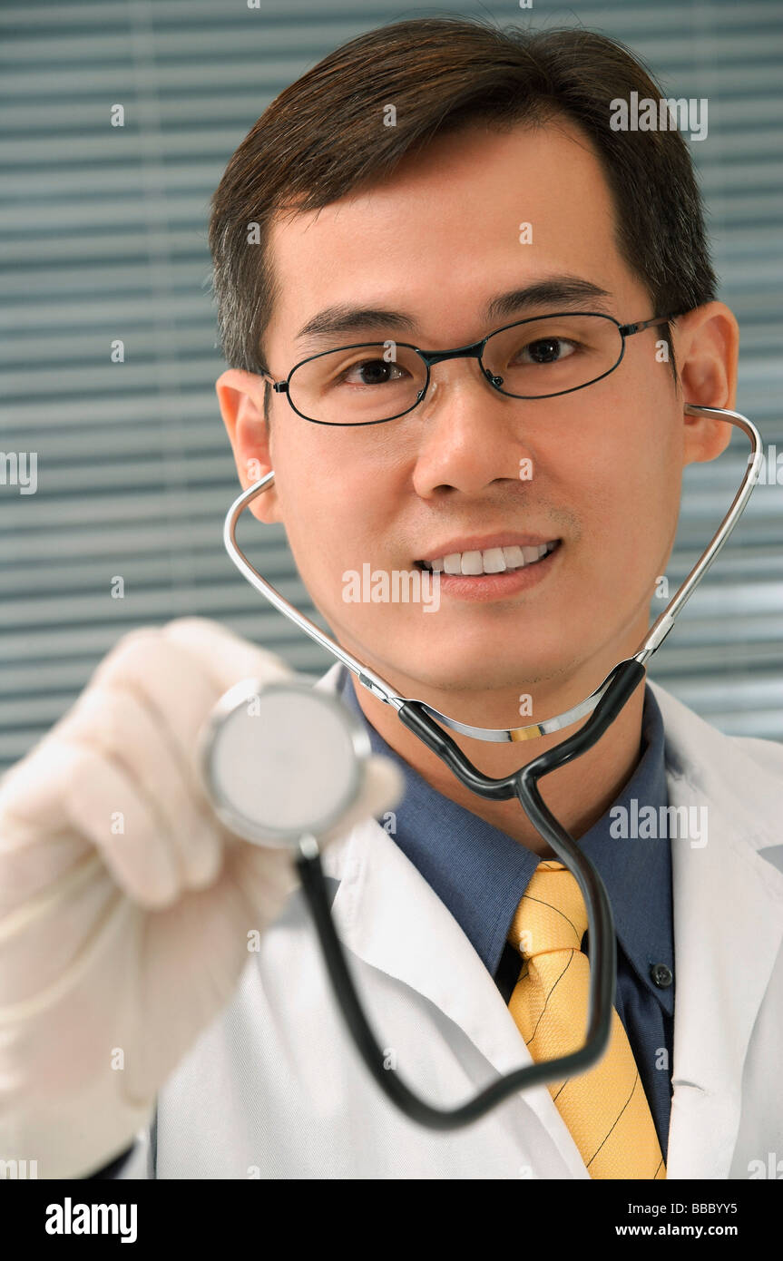 Doctor with stethoscope smiling at camera Stock Photo - Alamy