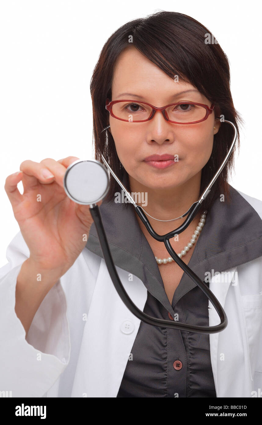Doctor holding up stethoscope and looking at camera Stock Photo - Alamy