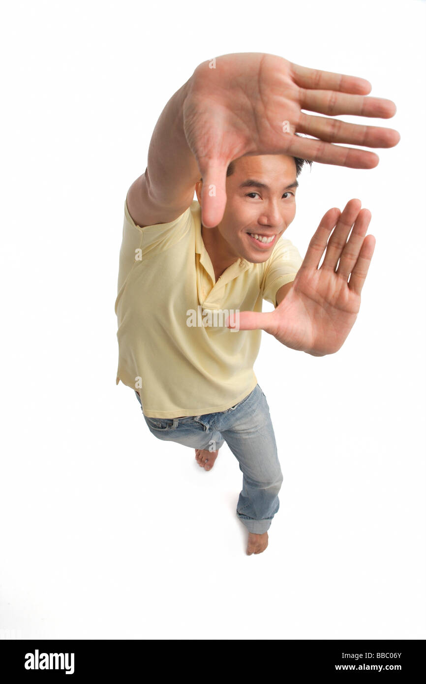 Man making frame with hands while smiling at camera Stock Photo - Alamy
