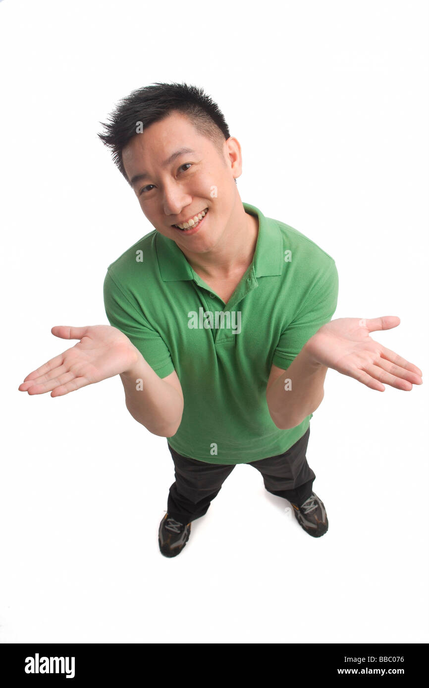 Man shrugging while smiling at camera Stock Photo - Alamy