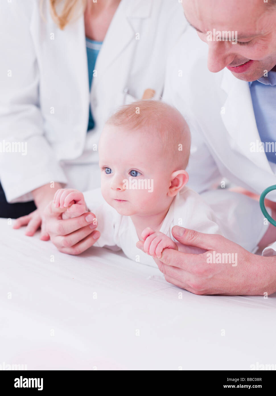 two medics tending to a baby Stock Photo - Alamy