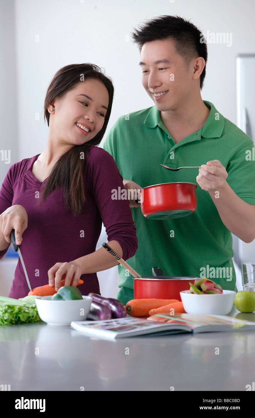 Couple cooking together Stock Photo - Alamy