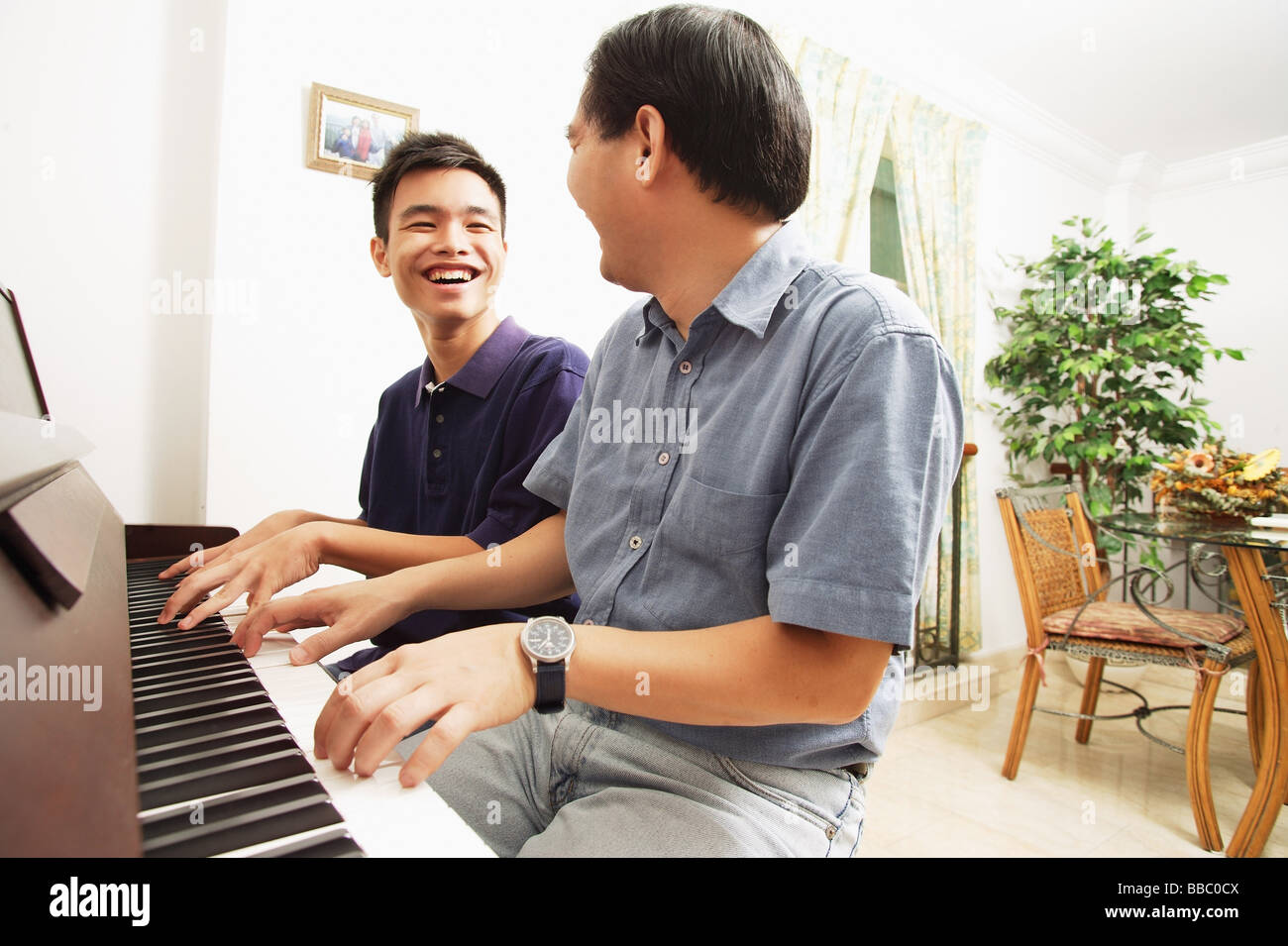 Father and son sitting at piano hi-res stock photography and images - Alamy