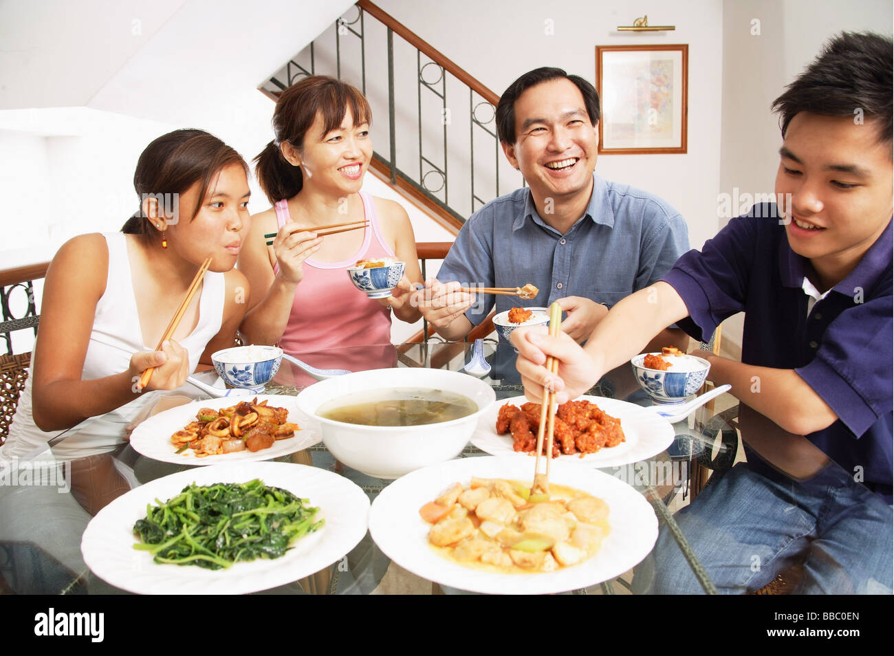 Family eating at home Stock Photo - Alamy