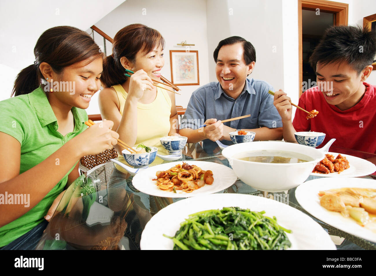 Family eating dinner at home Stock Photo - Alamy