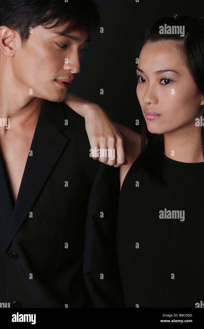 Young couple leaning on each other Stock Photo - Alamy