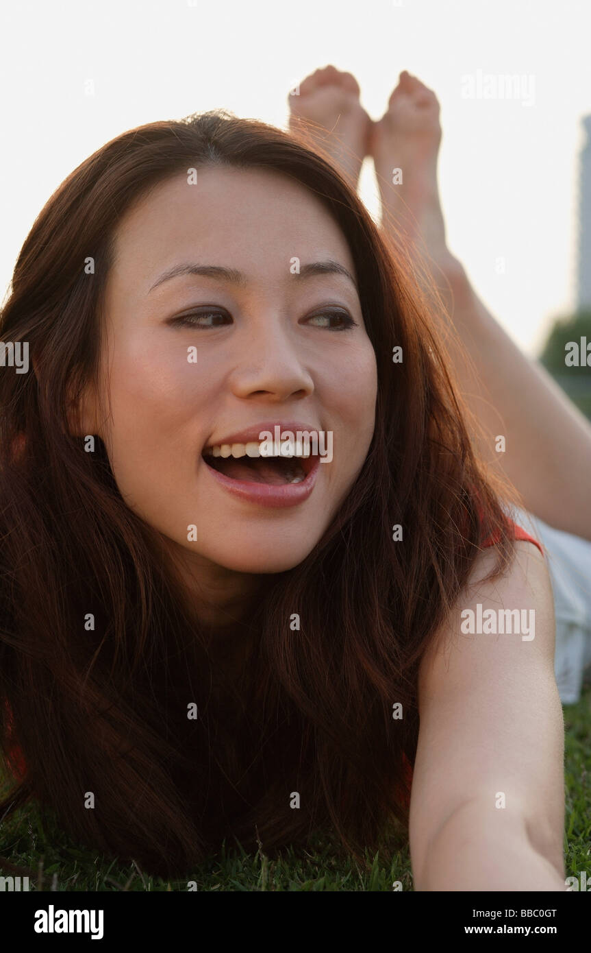 Woman laughing and looking sideways Stock Photo - Alamy